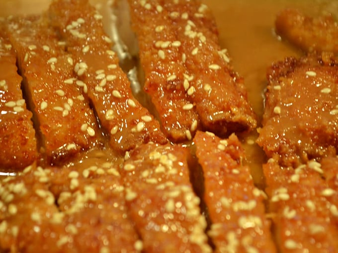 These glazed morsels glisten with sweet possibility, their sesame seed confetti promising a celebration for your taste buds.