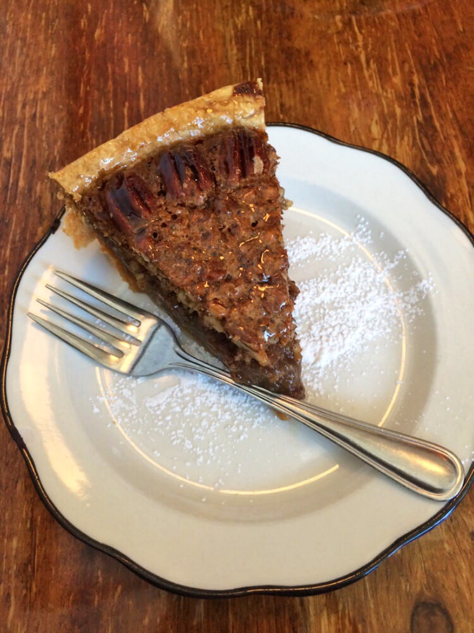 Pecan pie perfection on a plate. The glistening filling and perfectly arranged nuts make this slice the Mona Lisa of Southern desserts.