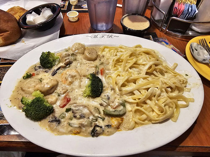 Pasta swimming in creamy sauce alongside perfectly cooked vegetables&mdash;proof that heaven might actually be a plate of comfort food.