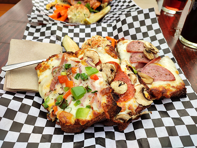Melted cheese cascading over toasted bread alongside a perfectly formed crab cake&mdash;proof that comfort food can still surprise after all these years.