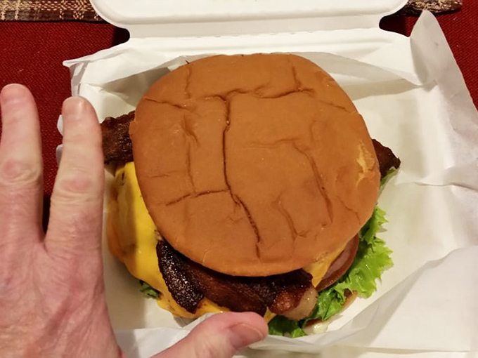 Hand-to-burger ratio check: You'll need both hands and possibly a game plan to tackle this masterpiece of beef and cheese.