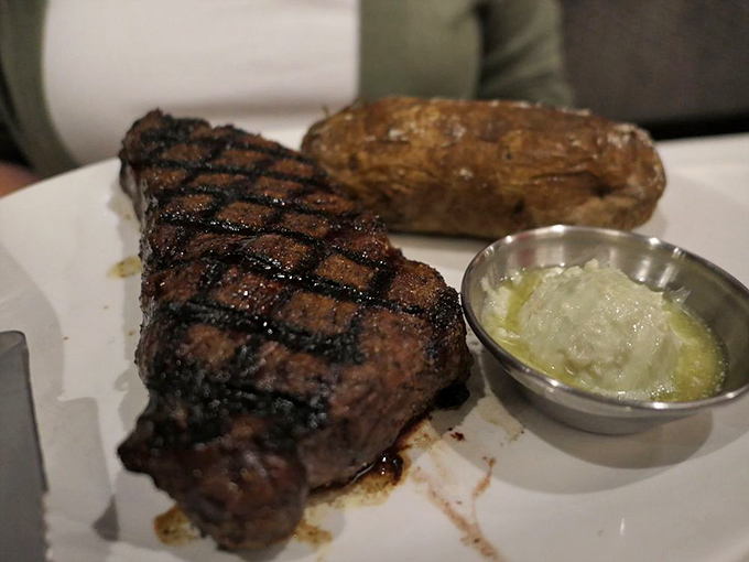 The star of our show: a Prime NY Strip with textbook char, paired with a loaded baked potato that's practically begging to be devoured.
