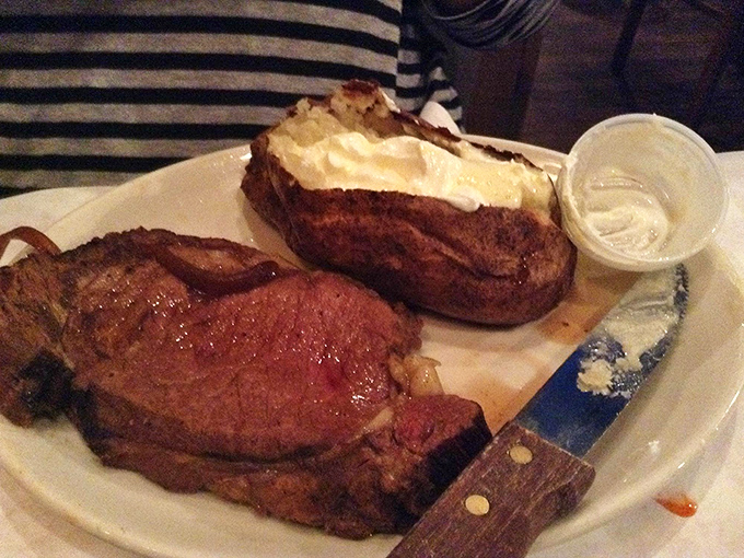 The steak knife isn't just a utensil here, it's your ticket to a perfectly cooked prime rib with a baked potato that's dressed to impress.