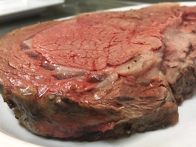 Behold the carnivore's dream—prime rib with a crust that crackles and meat so tender it practically surrenders at the sight of your fork.