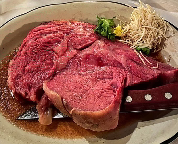The prime rib up close reveals its perfect pink interior&mdash;a testament to slow-roasting mastery that would make even the most stoic chef shed a tear of joy.