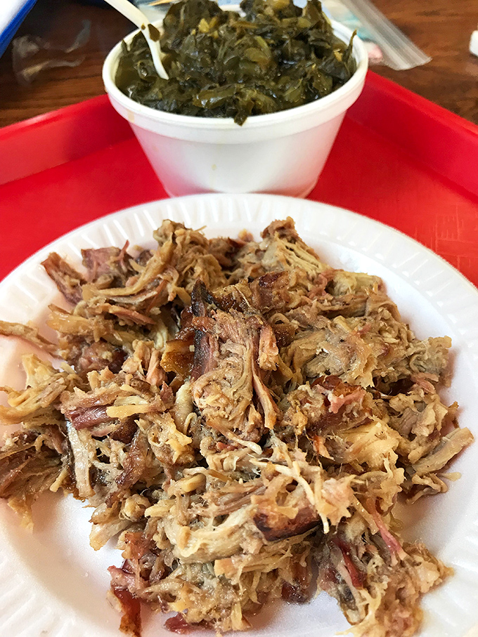 Pulled pork that's achieved the perfect balance of bark and tenderness. Those collard greens alongside aren't playing backup&mdash;they're co-starring in this delicious drama.