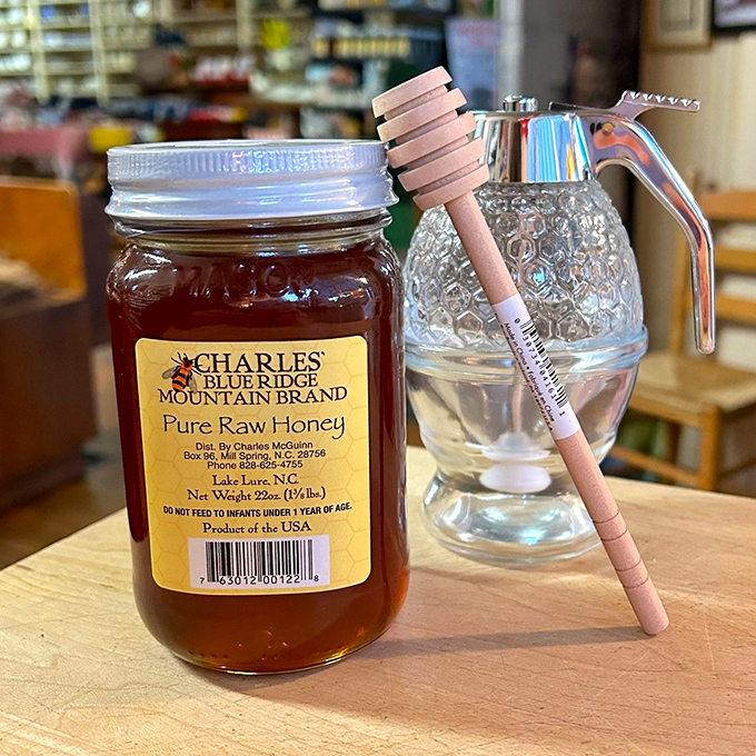 Liquid gold in a jar &ndash; local raw honey complete with wooden dipper, nature's sweetener the way your great-grandparents enjoyed it.