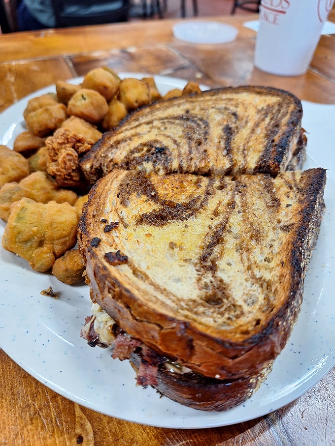This isn't just any Reuben sandwich; it's architectural perfection with layers of flavor that would make even New York delis nod in respect.