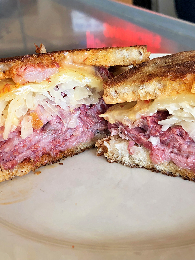 Architecture of deliciousness&mdash;layers of hand-sliced corned beef, tangy sauerkraut, and melted Swiss create a sandwich skyline worth admiring.