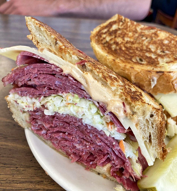 This isn't just a Reuben; it's a skyscraper of corned beef with Swiss cheese and sauerkraut playing supporting roles in this delicious drama.
