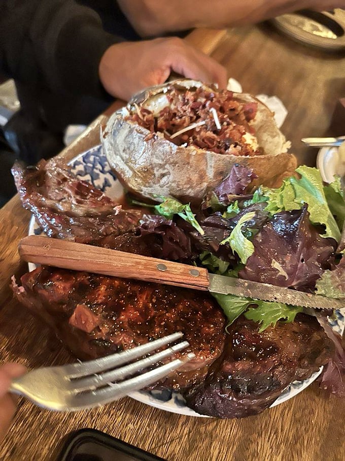 The kind of ribeye that makes vegetarians question their life choices. That wooden-handled knife isn't just for show.