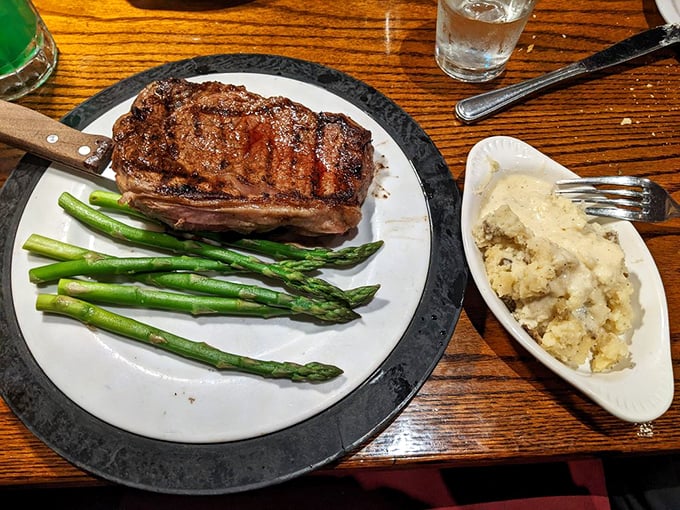 A ribeye that could make a vegetarian question their life choices, flanked by asparagus that actually makes you want to eat your vegetables.
