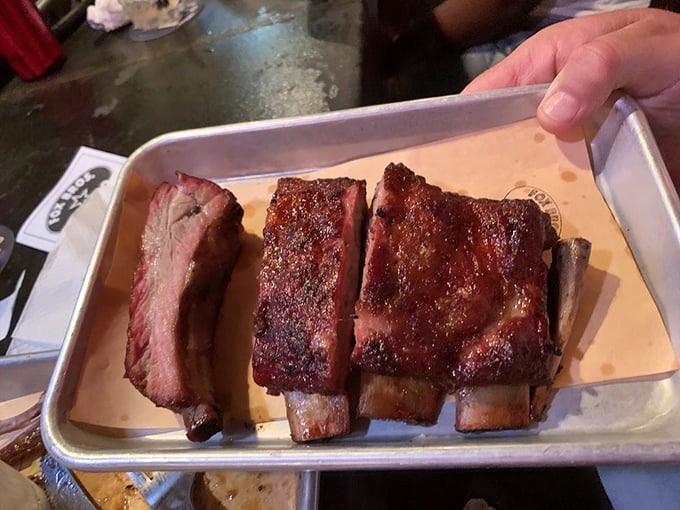 The smoke ring on these ribs tells a story of patience and expertise that no rushed meal could ever match.
