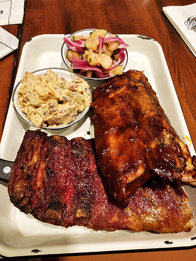 BBQ artistry on full display: two styles of ribs flanking homemade potato salad and pickled vegetables&mdash;a plate that makes vegetarians question their life choices.