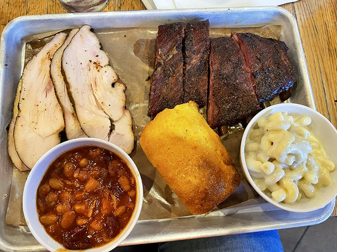 A meat lover's dream team: turkey that defies poultry's dry reputation, ribs with textbook smoke rings, and sides that aren't merely playing backup.