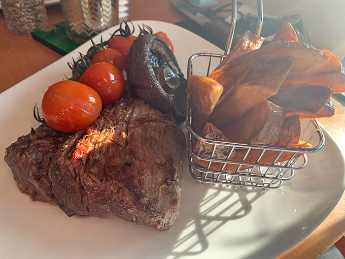 Steak perfection meets rustic presentation. Those roasted tomatoes add a pop of color that says, "Yes, vegetables matter too, but meat is king."