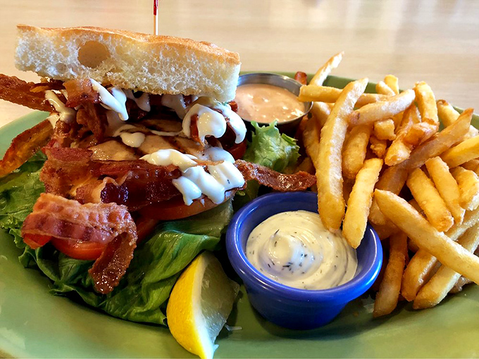 The ultimate power couple: seafood meets bacon in this glorious sandwich. It's like Romeo and Juliet, except everybody lives and gets to enjoy crispy fries.