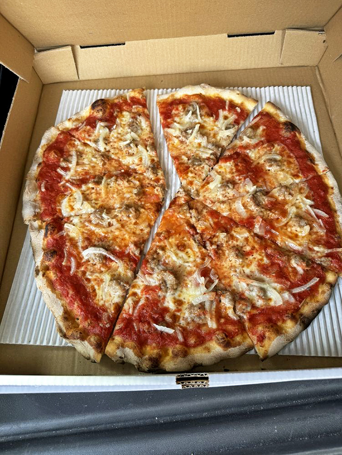 The white pie with spinach speaks the universal language of garlic. Those charred edges are the pizza equivalent of a perfect sunset. 