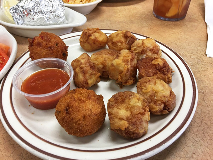 A plate that whispers "seafood symphony" – crispy hush puppies and tender fried seafood that would make Captain Ahab forget all about that whale.