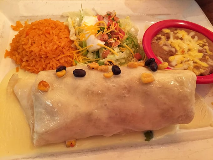 The seafood burrito arrives like a gift from the ocean, wrapped in a tortilla blanket and crowned with corn confetti.