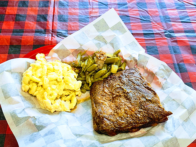 The holy trinity of Southern comfort: mac and cheese, green beans, and a brisket that's been smoking longer than some folks have been driving.