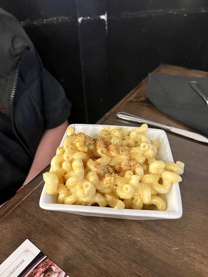 This unassuming white bowl contains what I'm convinced is the eighth wonder of the world—mac and cheese so creamy it should require a permission slip.