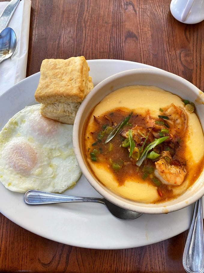 The complete shrimp and grits experience&mdash;creamy cheese-laden heaven with a biscuit sidekick that deserves its own fan club.