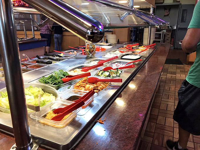 A rainbow of fresh ingredients awaits, from vibrant green beans to golden lo mein, each tray a different chapter in your feast story.