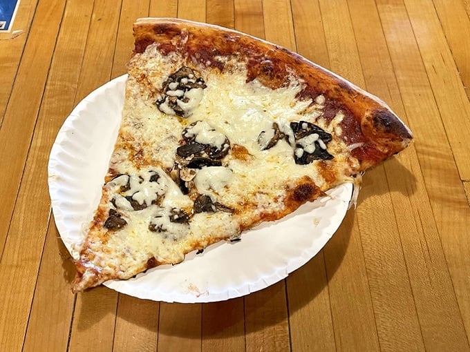 This slice of mushroom pizza demonstrates the perfect cheese-to-crust ratio&mdash;the kind that makes you wonder why you ever settled for delivery.