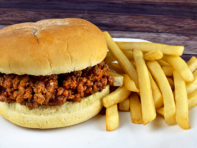 The Sloppy Joe&mdash;childhood nostalgia on a bun. This isn't just comfort food; it's a time machine that happens to come with fries.