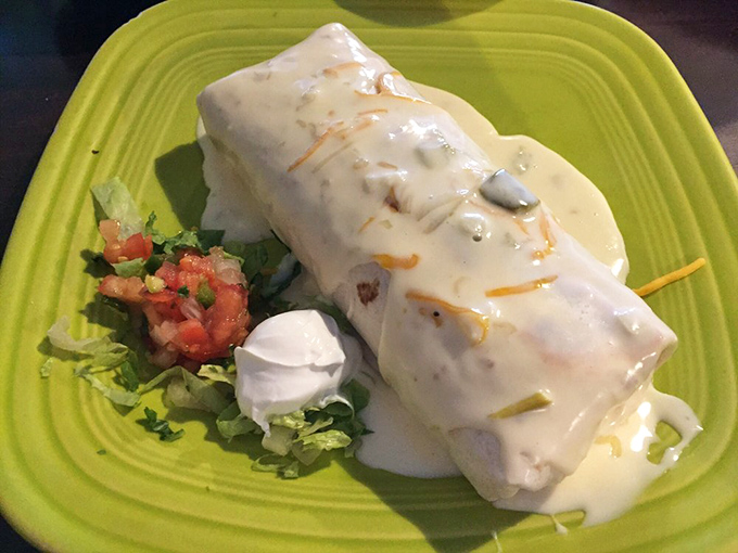 Some call it a smothered burrito; I call it the reason stretchy pants were invented. That green chile sauce is liquid gold.
