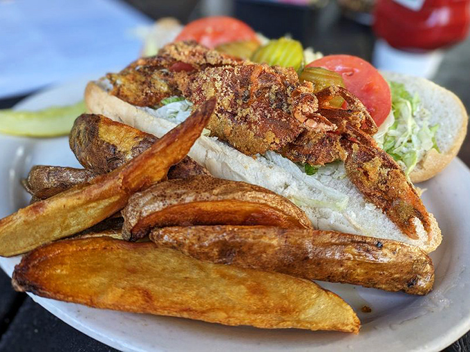 This isn't just a sandwich; it's architecture. Crispy potato wedges stand guard beside a po-boy that would make New Orleans proud.