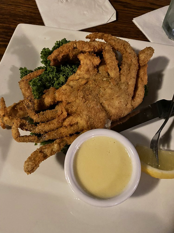 The soft shell crab arrives golden and crispy, accompanied by a sauce that would make even the most committed landlubber consider a life at sea.