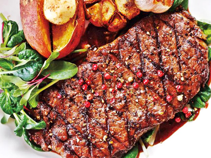 This isn't just a steak; it's a carnivore's sonnet&mdash;perfectly seared, seasoned with authority, and resting on a bed of fresh greens.