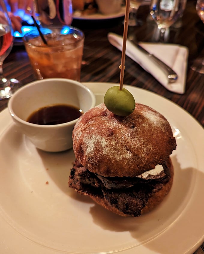 This isn't just a sandwich; it's architectural brilliance with beef. The olive spear plants a flag claiming victory over hunger.