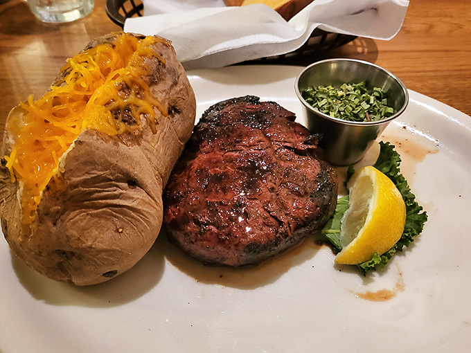 That loaded baked potato could be a meal itself, but it knows its place&mdash;loyal sidekick to the smoky, flame-kissed filet that's the undisputed star of this plate.