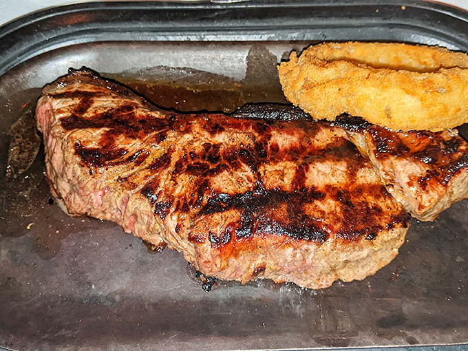 A masterclass in contrast: charred exterior, rosy interior, and that onion ring&mdash;the halo every great steak deserves. Simplicity elevated to art form.