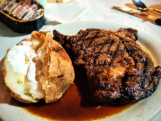 This isn't just dinner; it's a primal satisfaction wrapped in grill marks, where a perfectly cooked ribeye swims in its own magnificent juices.