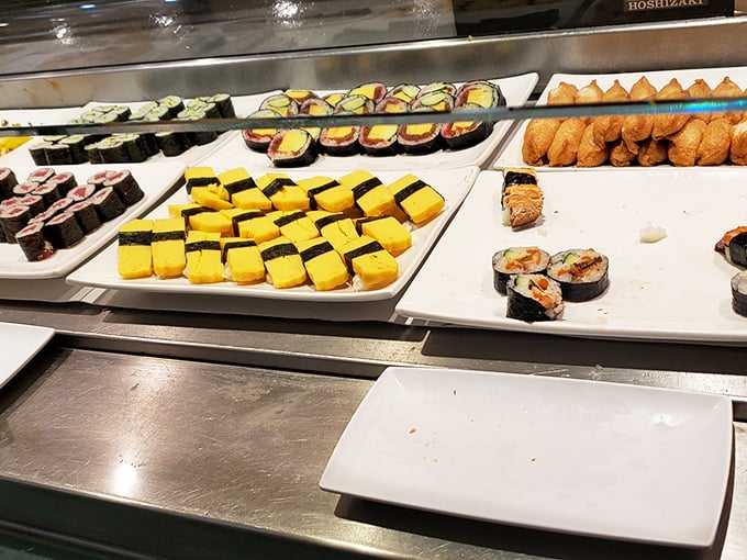 Sushi paradise awaits with neat rows of colorful maki rolls. The tamago (sweet egg) nigiri brings a sunny pop of yellow to this seafood rainbow.