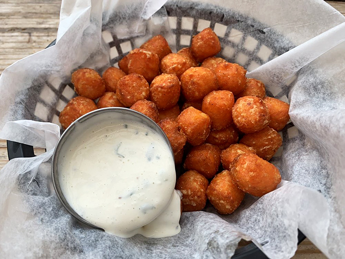 Golden-brown sweet potato tots that crunch like teenage dreams, served with a dipping sauce so good you'll consider drinking it straight. No judgment here.