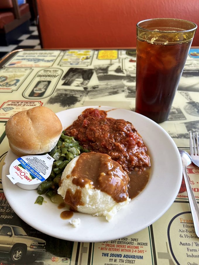 Comfort on a plate – mashed potatoes drowning happily in gravy, green beans for color, and Swiss steak that's been simmering since sunrise.