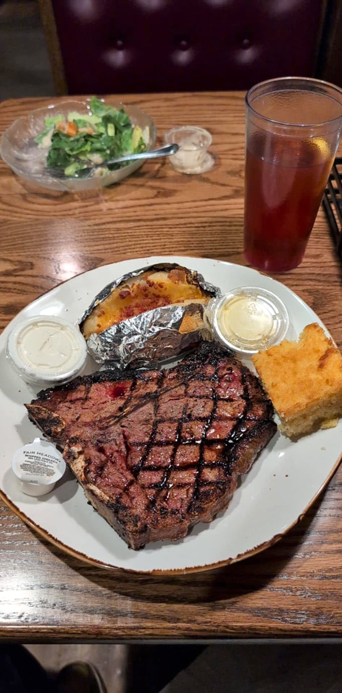 This T-bone doesn't just cross the finish line—it wins the Kentucky Derby of steaks. Those grill marks tell stories of flame-kissed perfection.