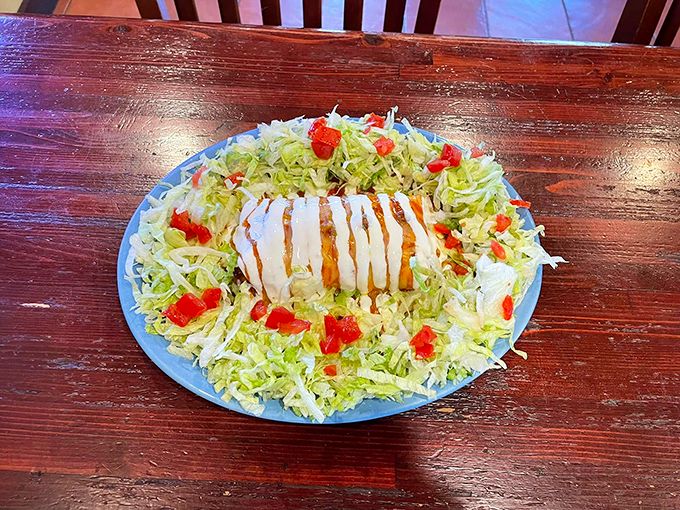 A taco salad with architectural ambition! This crispy tortilla bowl cradles seasoned beef, cheese, and fresh veggies like a delicious edible treasure chest.