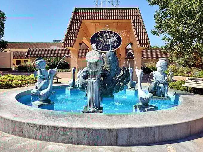 The Precious Moments Chapel fountain features the distinctive big-eyed figurines that became a nationwide collecting phenomenon, now in a serene outdoor setting.