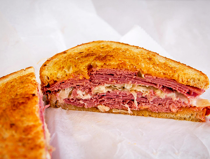 This isn't just a sandwich&mdash;it's architecture. The golden-toasted rye bookends a masterpiece of meat, cheese, and tangy goodness that defines the Malin's Reuben.