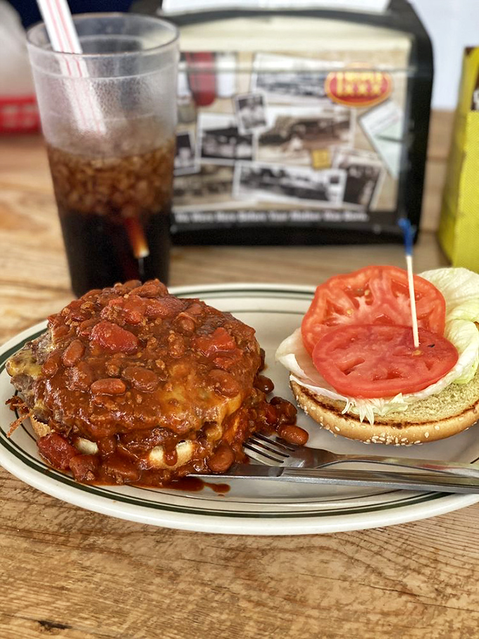 Chili cascading down burger mountains with the confidence of Niagara Falls. This plate demands both napkins and respect.