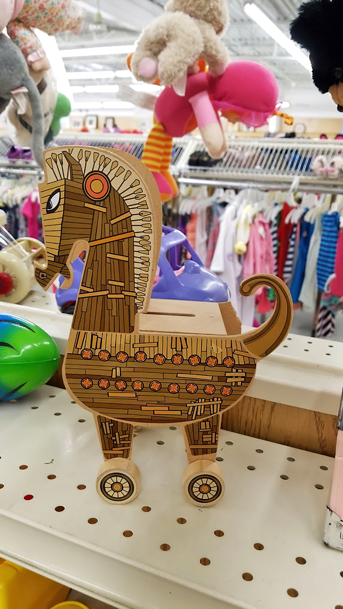 A wooden Trojan horse bank stands guard in the toy section. Like everything here, it's both completely unnecessary and absolutely essential to someone's happiness.