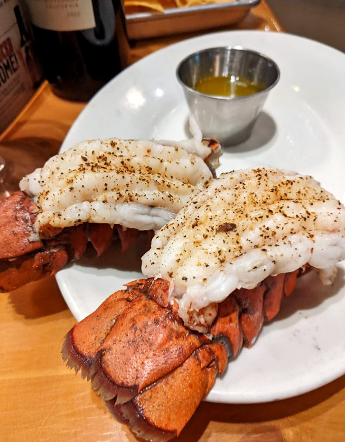 These twin lobster tails aren't just seafood; they're ocean royalty making a grand appearance at your table.