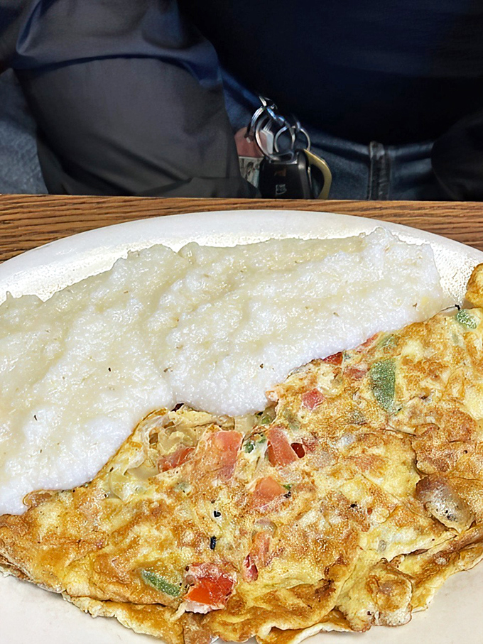 Behold the perfect marriage of fluffy eggs and colorful vegetables. Like a sunrise on your plate, with grits playing a supporting role.