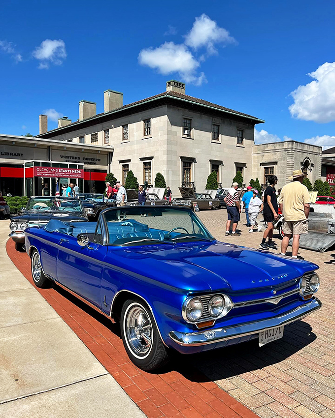 That gorgeous blue Corvair convertible steals the show outside the museum, proving some classics never go out of style.